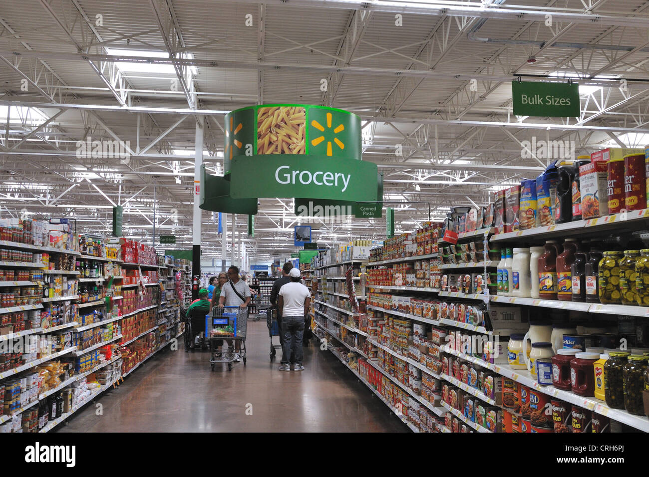 People pushing shopping carts in the grocery isle at Walmart Stock ...