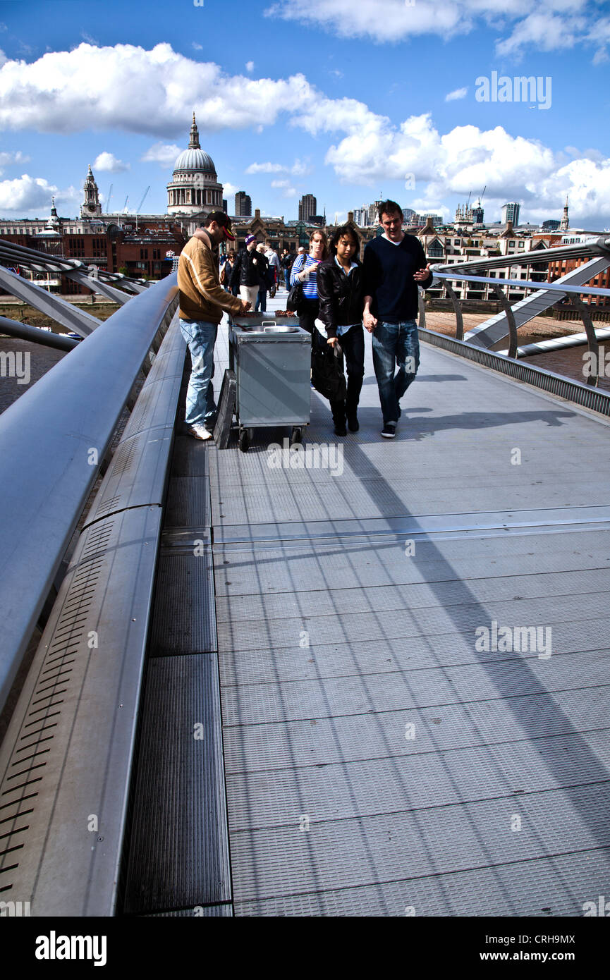 People Walking Across Millennium Bridge on Sunny Day Stock Photo - Alamy