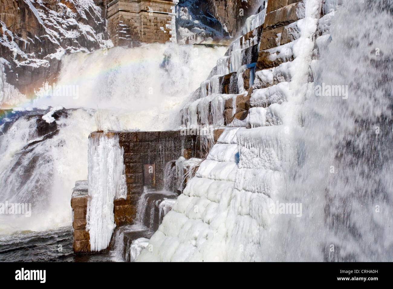 rainbow on river cascade in winter Stock Photo - Alamy