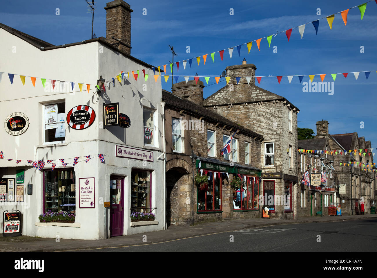 The streetscape of Hawes Retail Units bunting and shops of the village ...