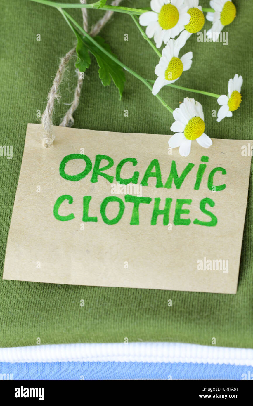 stack of colorful clothing with organic label Stock Photo - Alamy