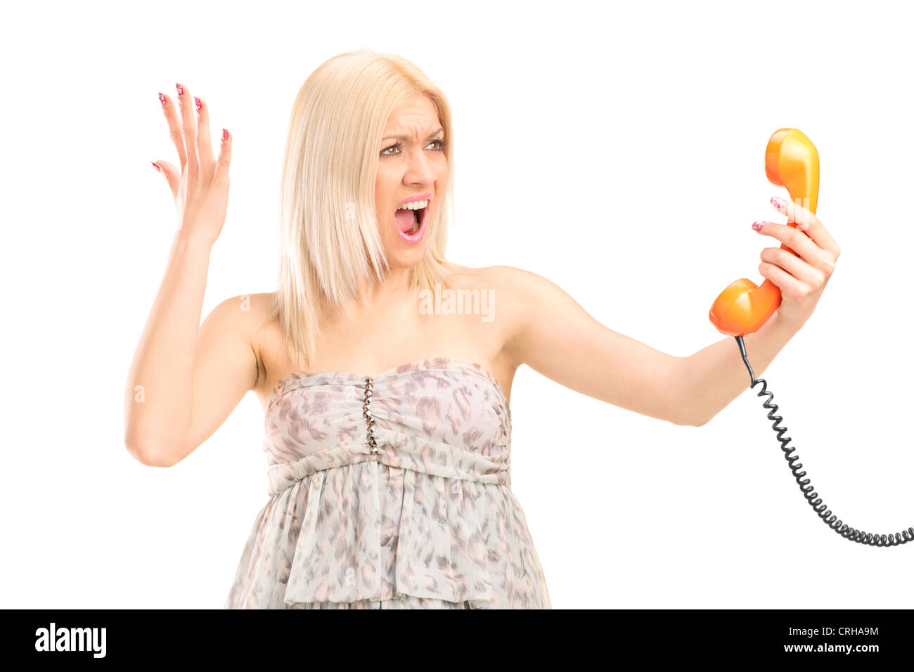 A shocked blond woman screaming on a phone isolated against white ...