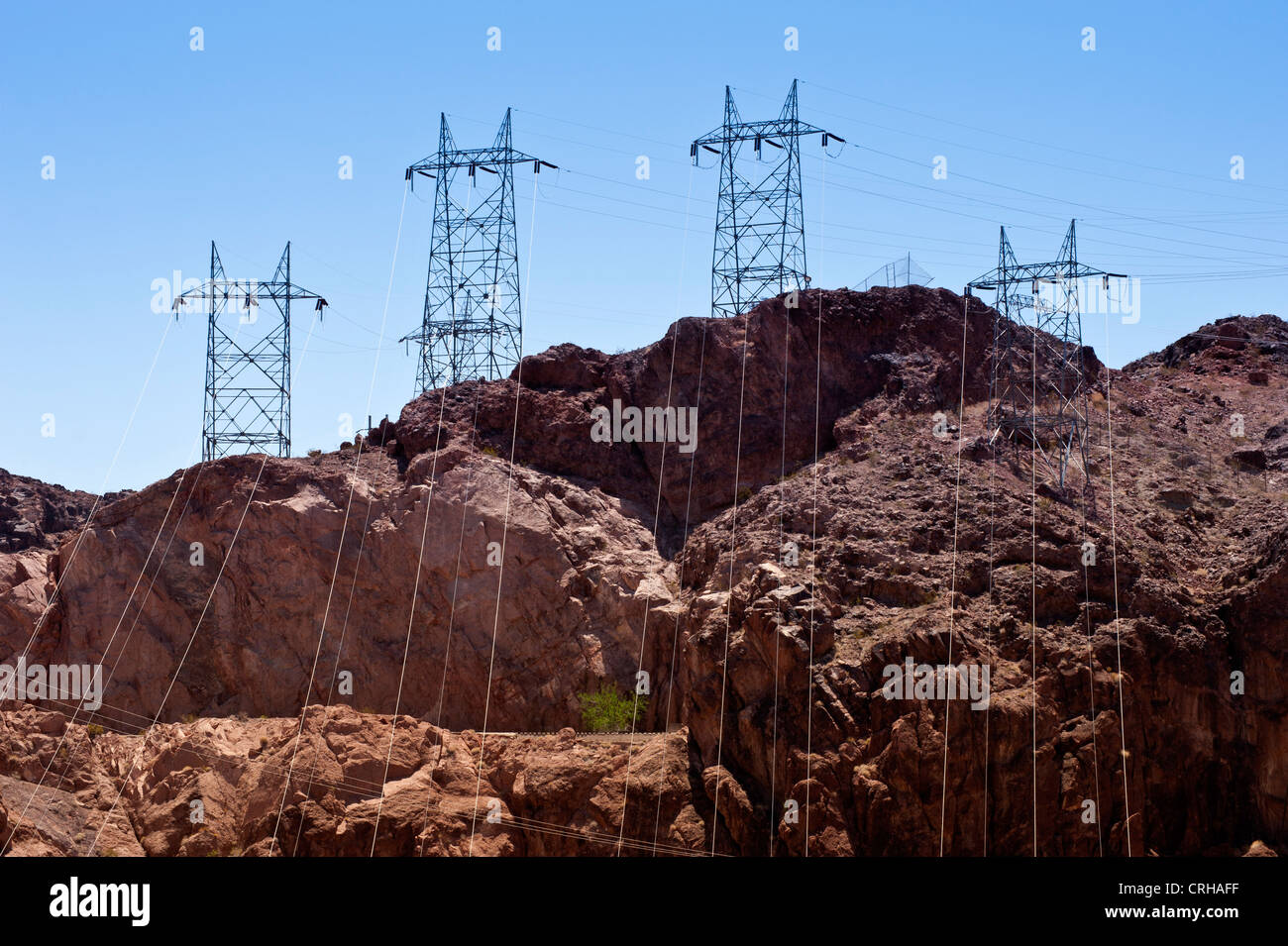 American transmission towers or electricity pylons on rocky ground ...