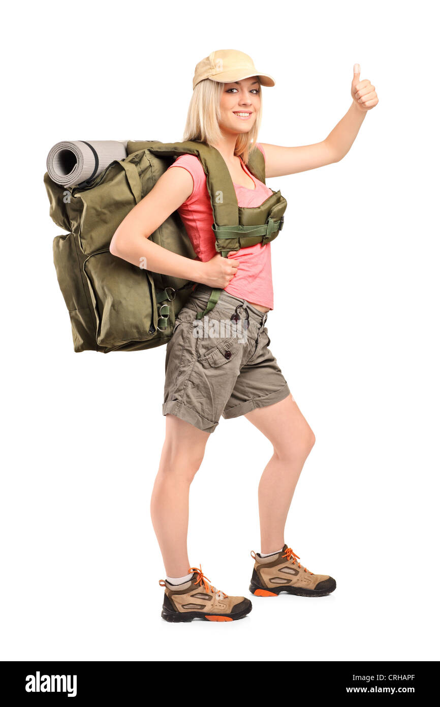 Full length portrait of a female hiker with backpack giving a thumb up ...