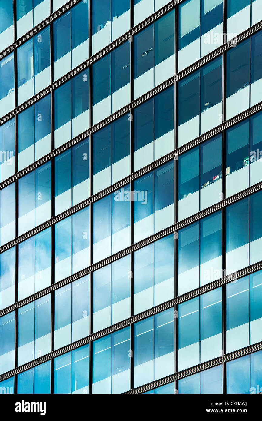Stormy rain clouds reflected in Office block glass windows. Tottenham ...