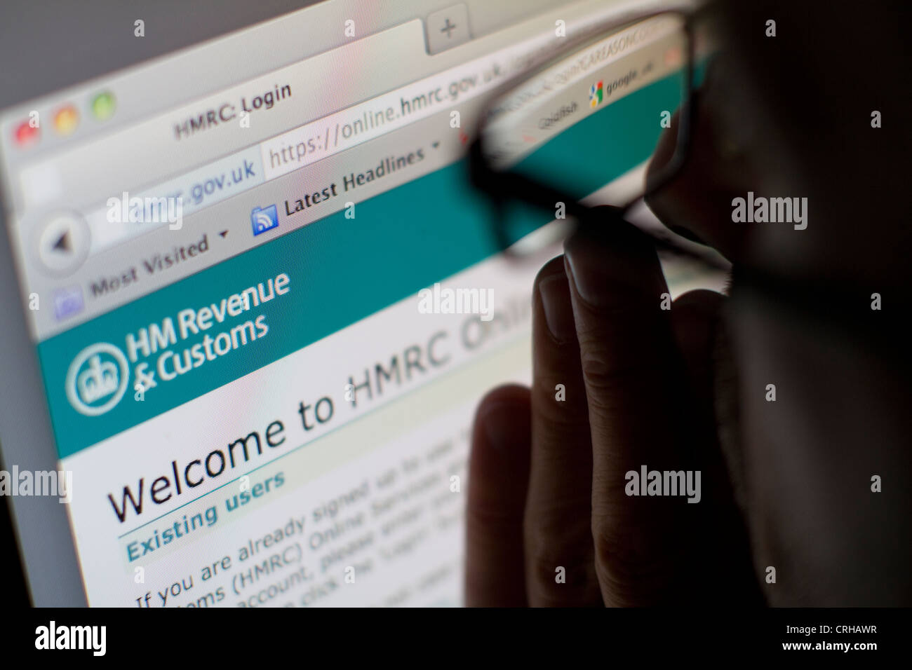 Person views HMRC website on a computer, accessing the UK tax system ...