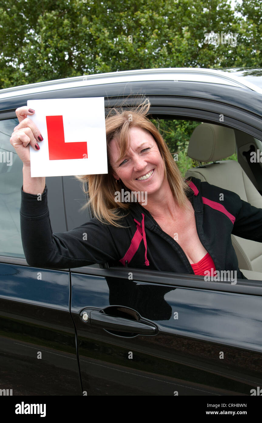 Woman smiling holding learner sign hi-res stock photography and images ...