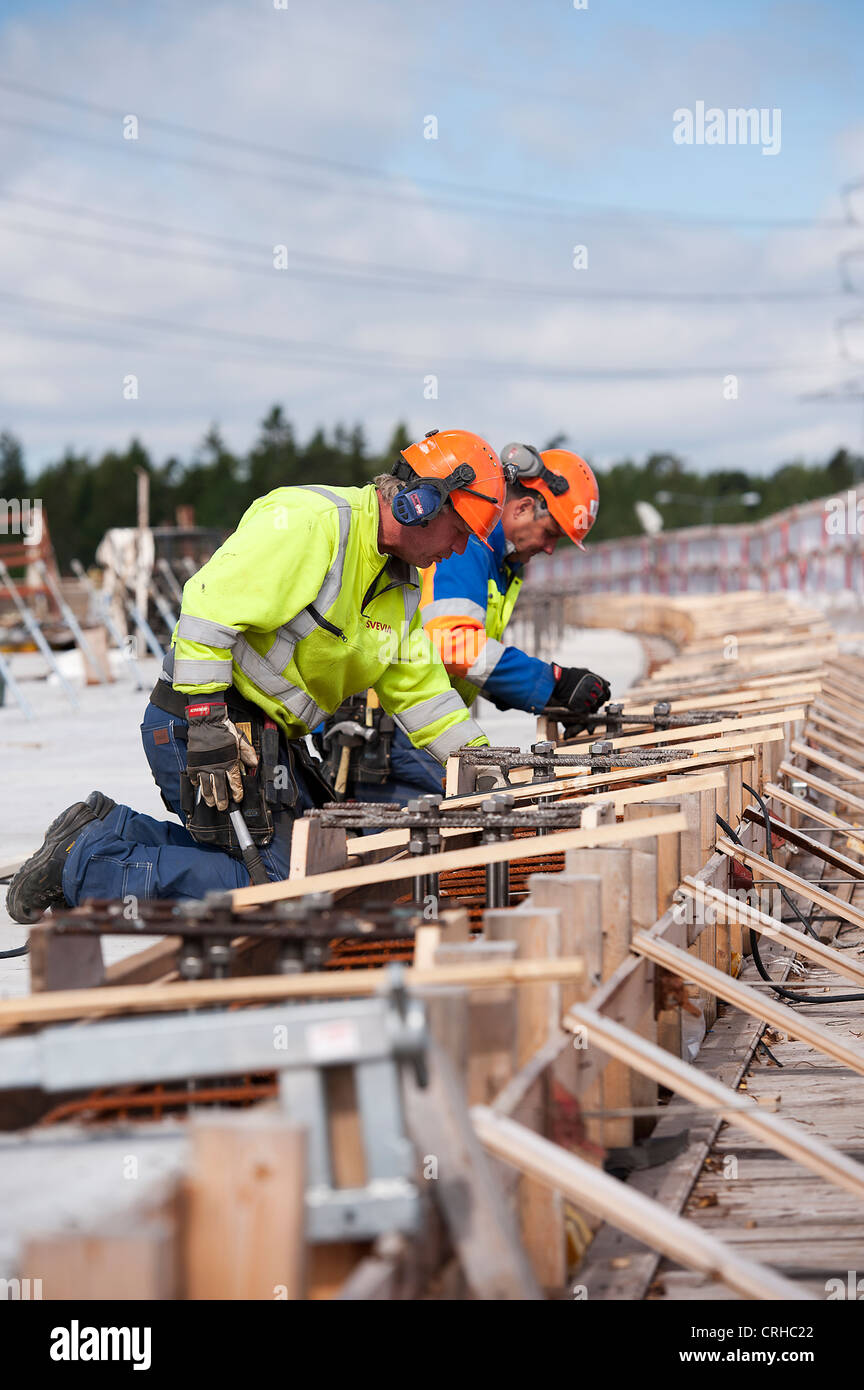 Construction workers on bridge Stock Photo - Alamy