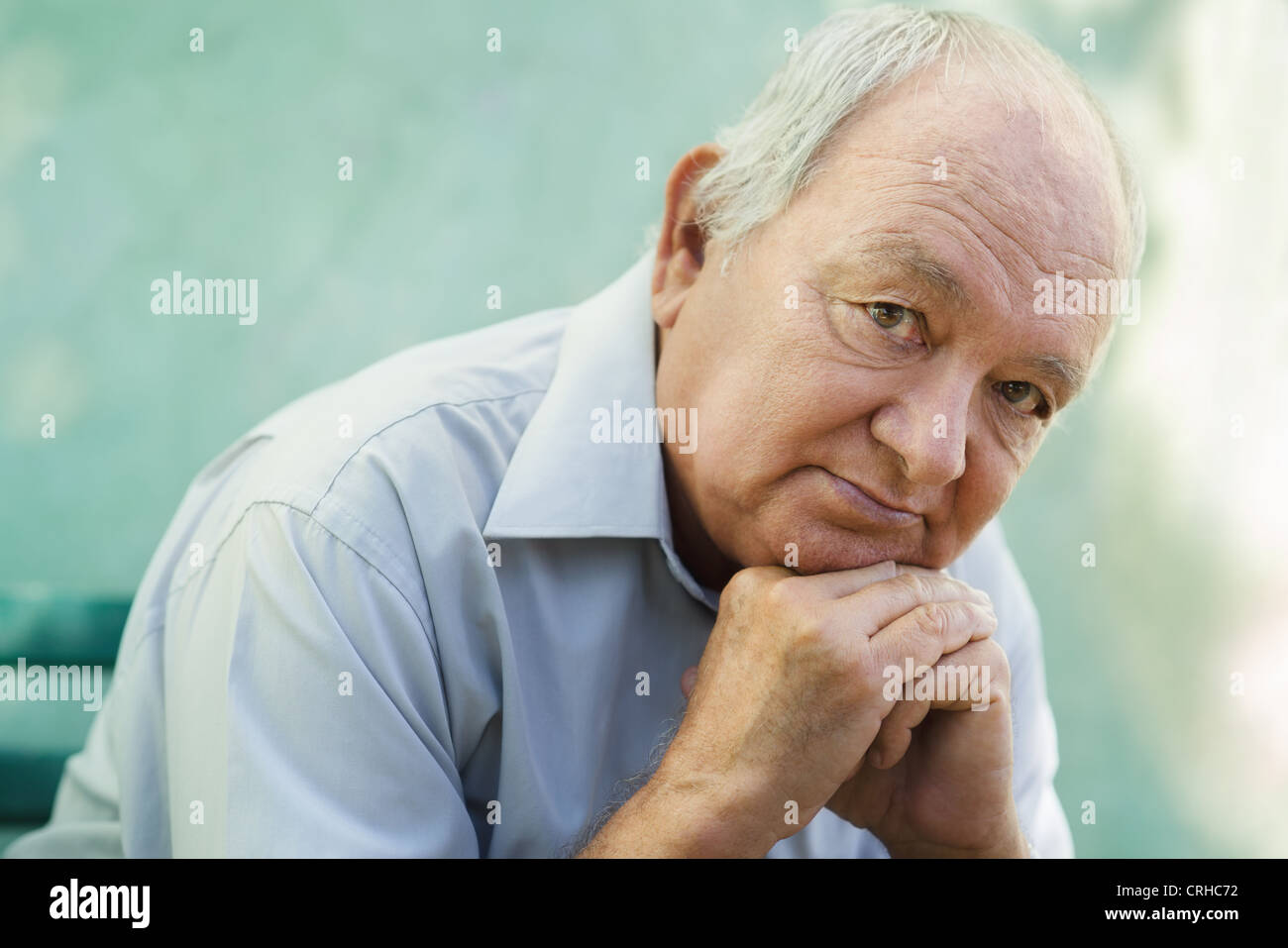 Seniors portrait of contemplative old caucasian man looking at camera ...