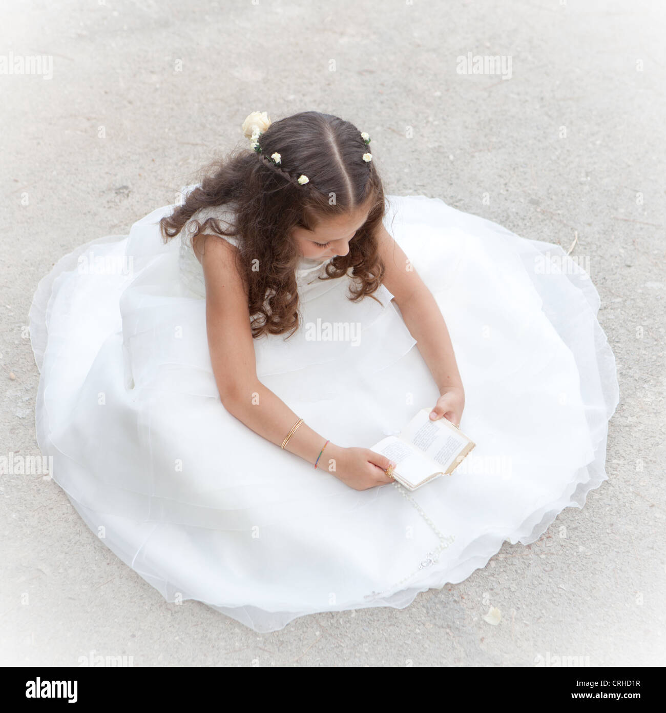 first communion or confirmation, child reading bible or prayer book ...