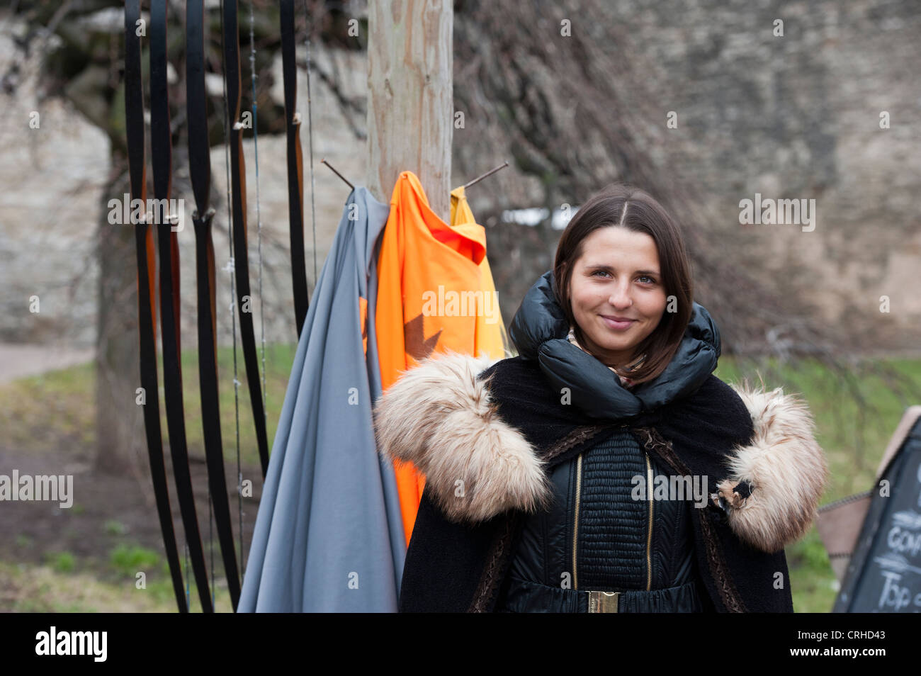 A pretty Estonian woman working at an archery stall in Tallinn, Estonia ...