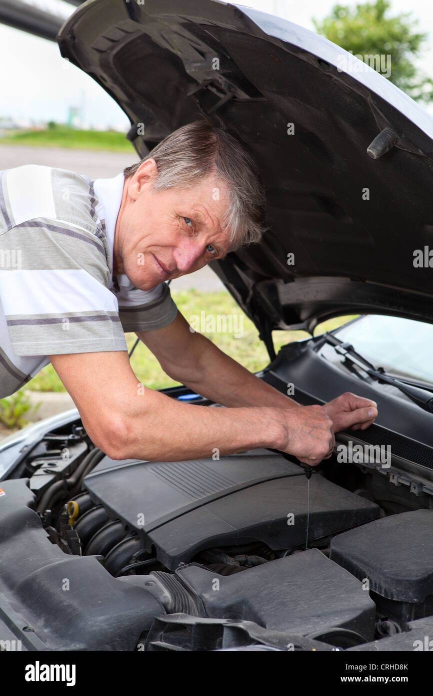 Adult man checking under the hood of car hi-res stock photography and ...