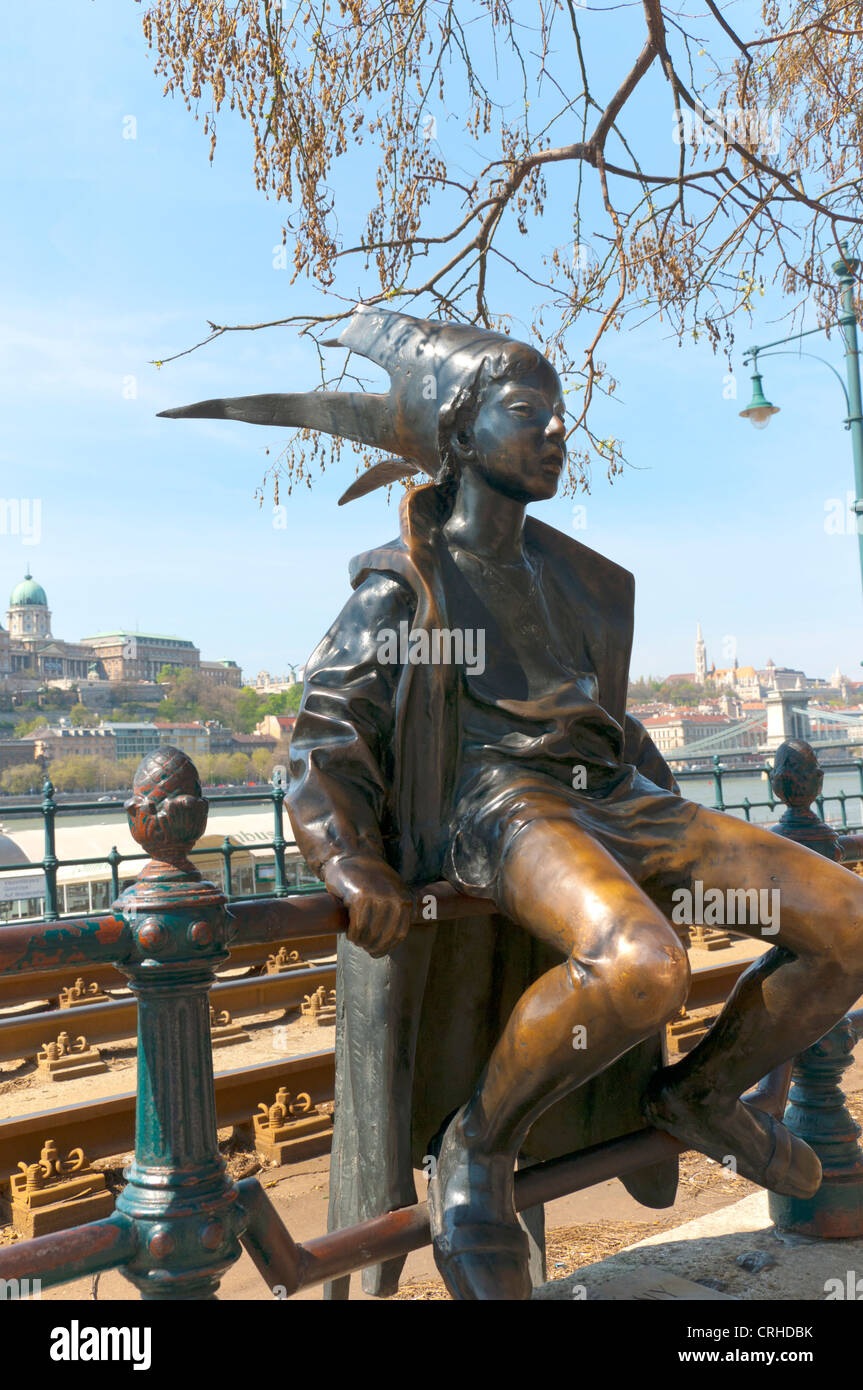 The statue of the Little Princess statue sitting on the railings of the Danube promenade in ...