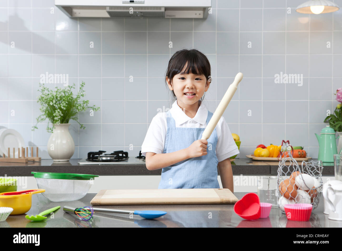 Little girl cooking in the kitchen Stock Photo - Alamy