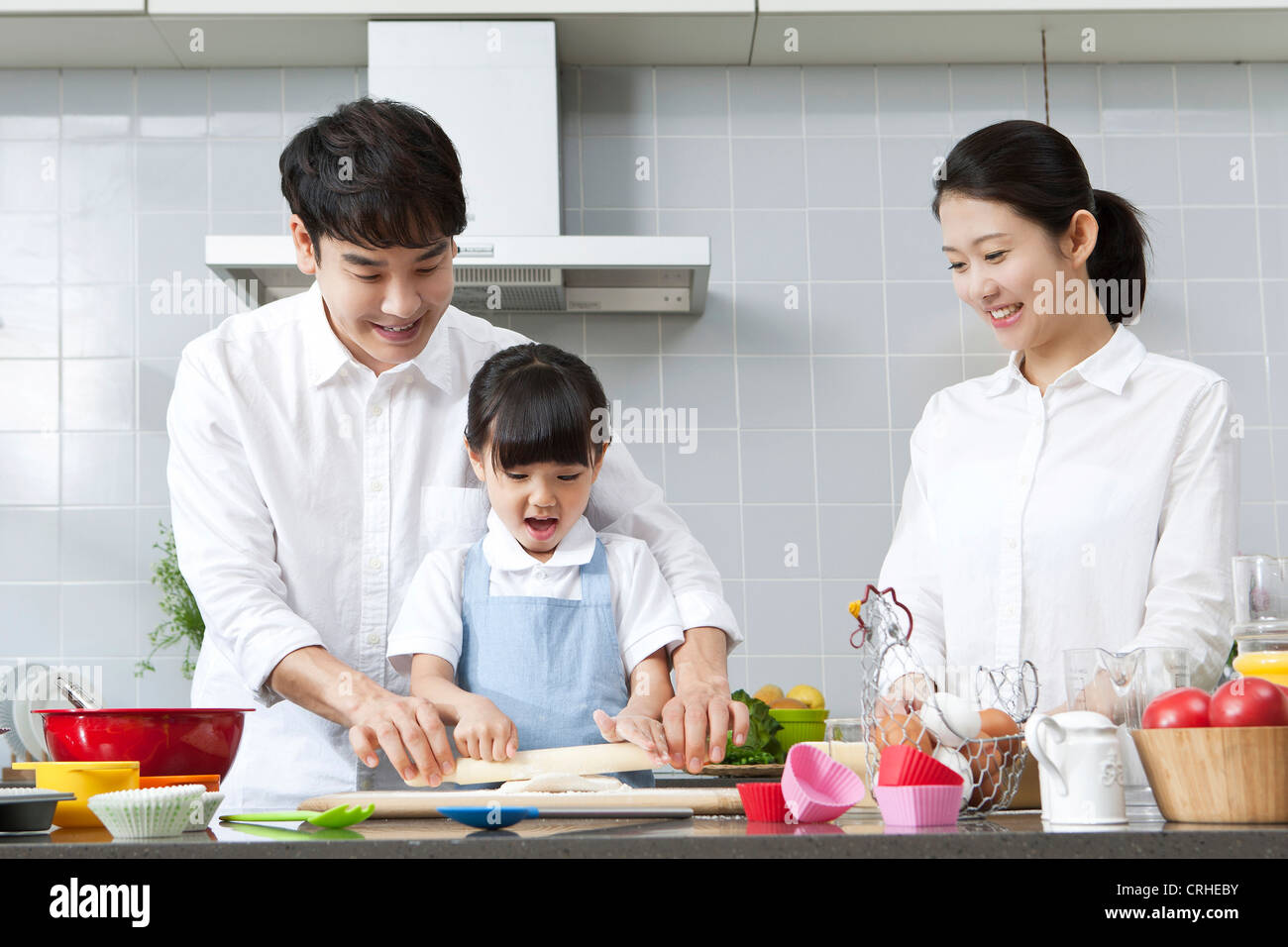 Happy family cooking in the kitchen Stock Photo - Alamy