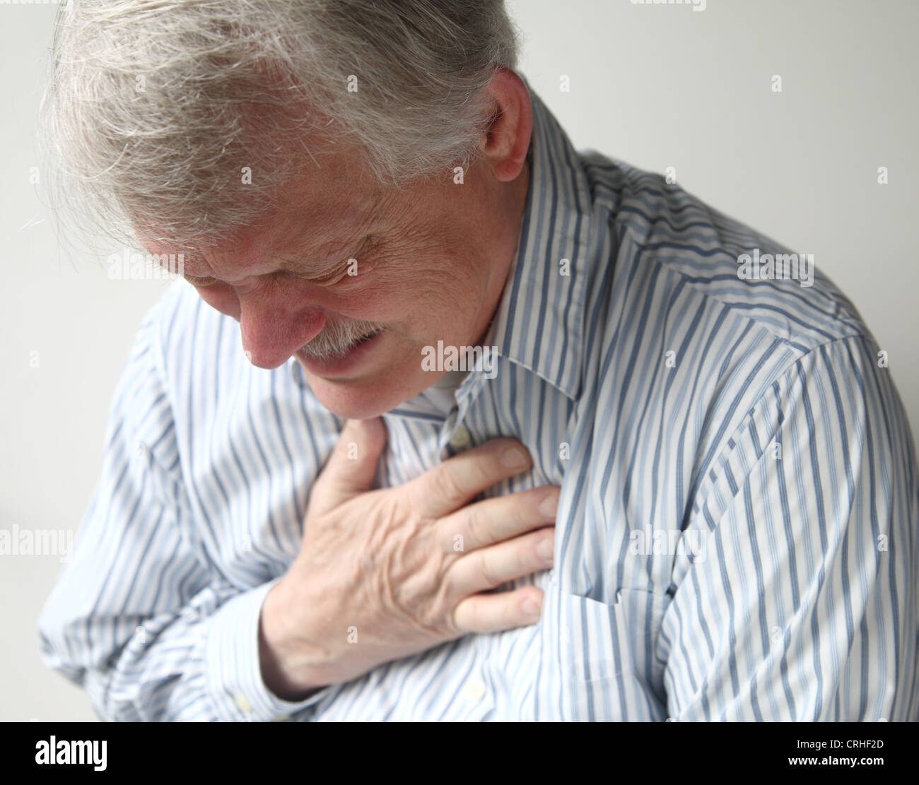 a senior man suffering from bad pain in his chest Stock Photo - Alamy