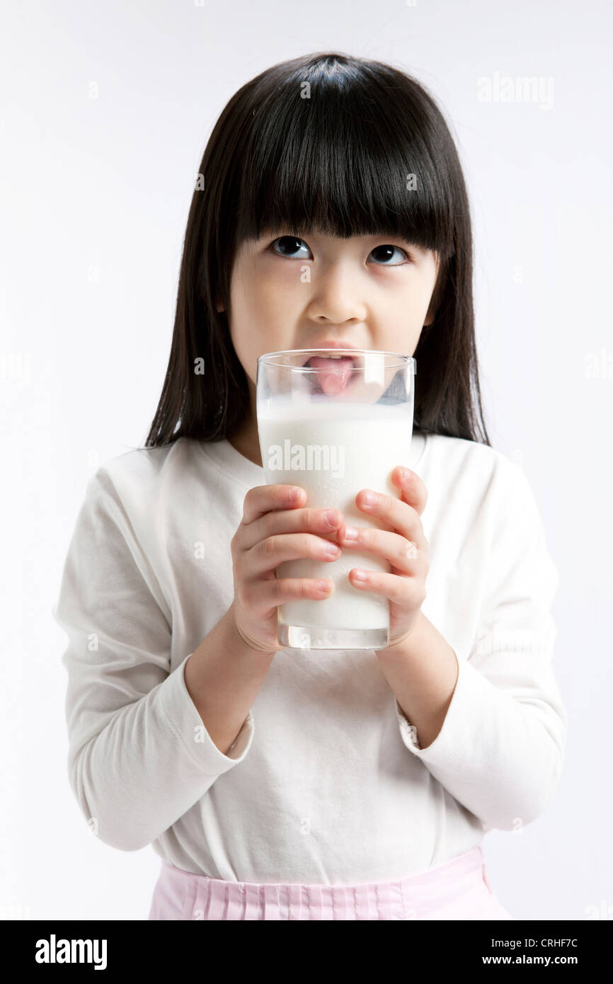 Little girl drinking milk Stock Photo - Alamy