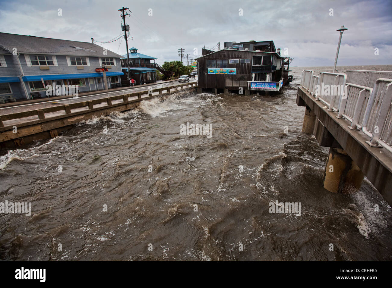 Waves crash against the seawall on Dock Street in downtown Cedar Key ...