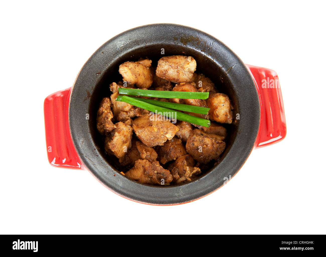 Baked chicken cubes in pan over white background Stock Photo - Alamy