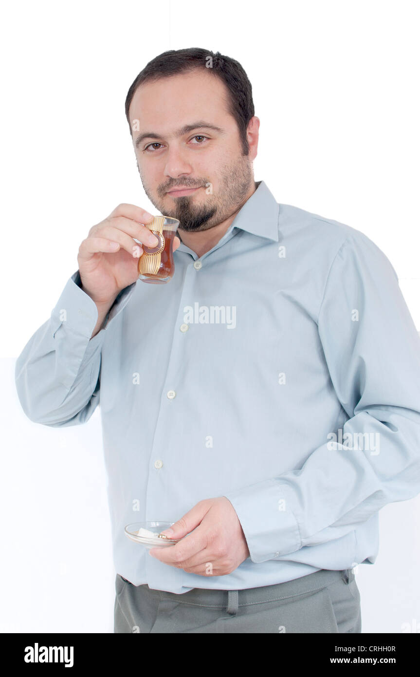 Young man drinking traditional turkish chai Stock Photo - Alamy