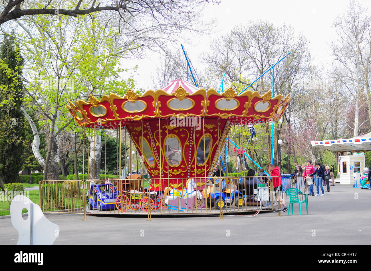 Red carousel in amusement park in daylight Stock Photo - Alamy