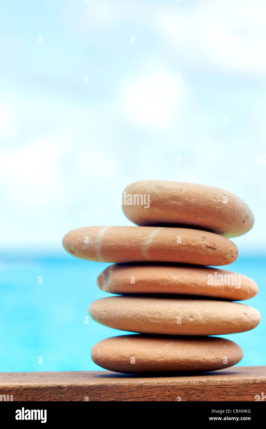 balancing beach pebbles or stones with the sea in the background Stock ...
