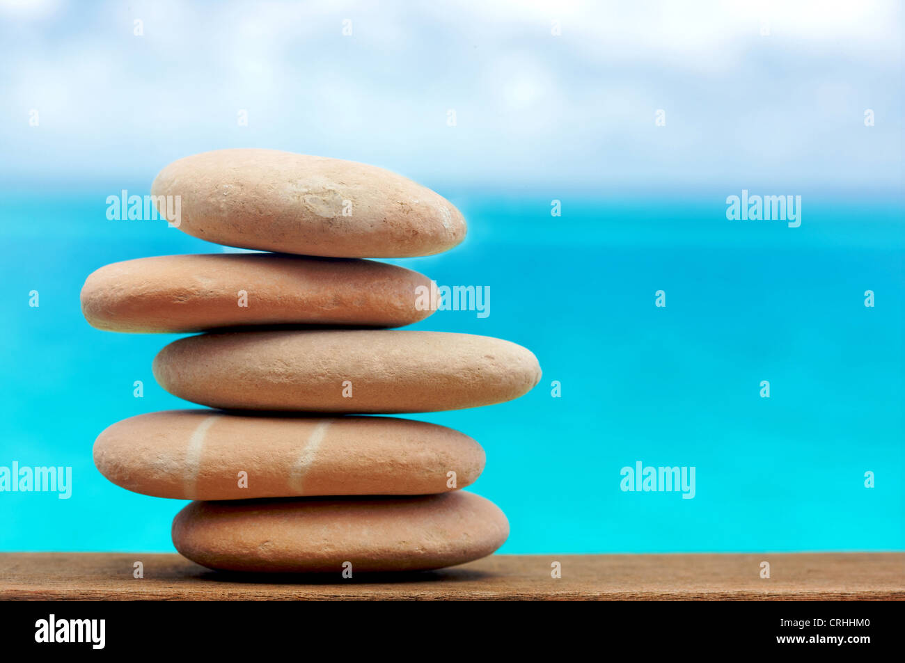 balancing beach pebbles or stones with the sea in the background Stock ...