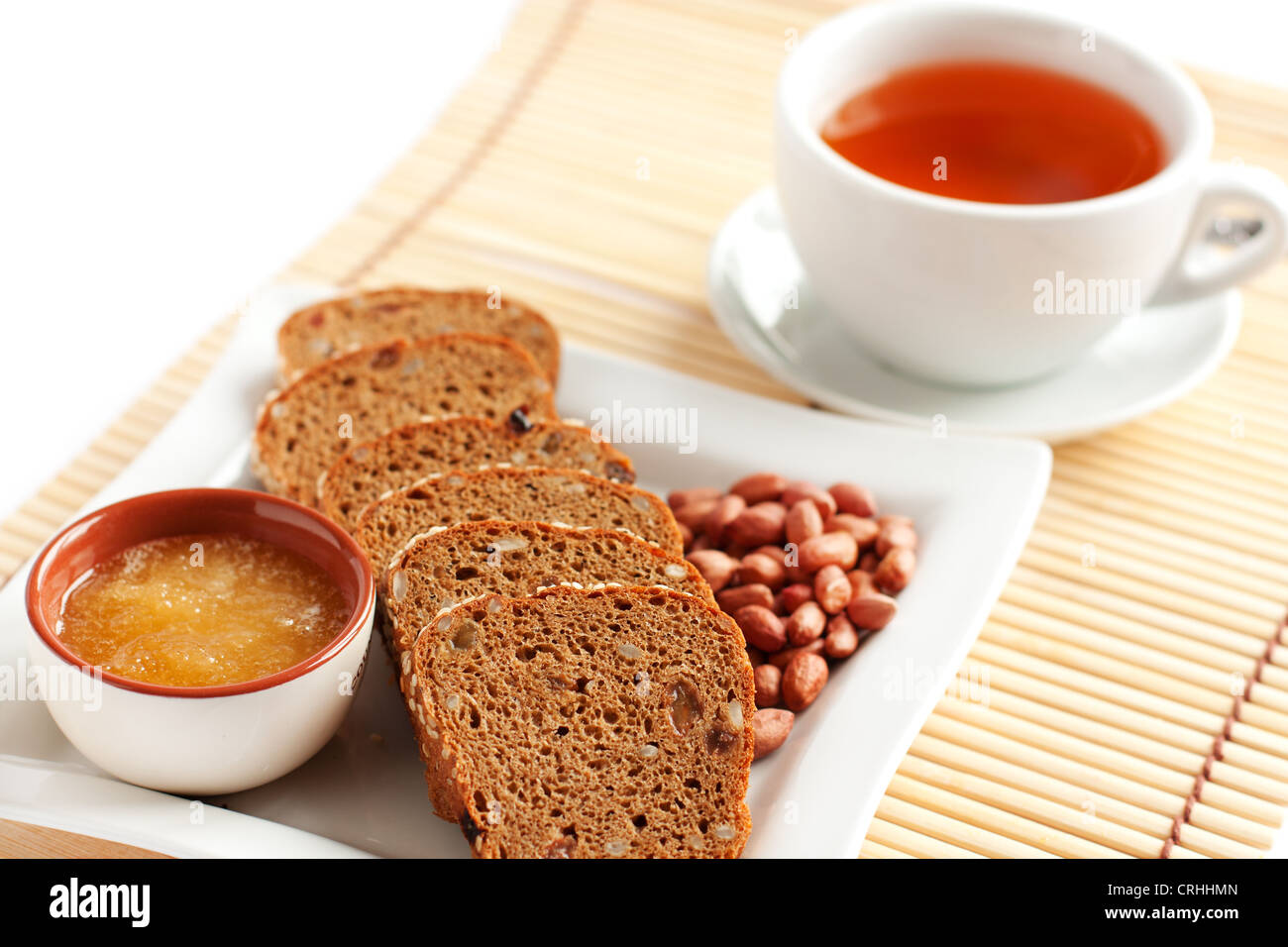 Tea with bread, flavored with honey and nuts on a bamboo napkin Stock ...