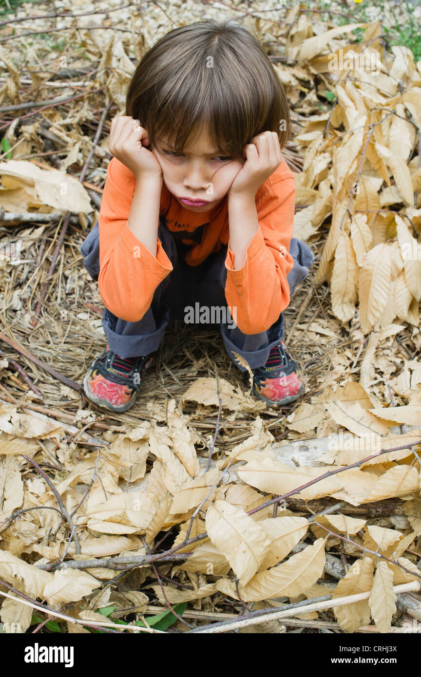 Boy sulking outdoors Stock Photo - Alamy
