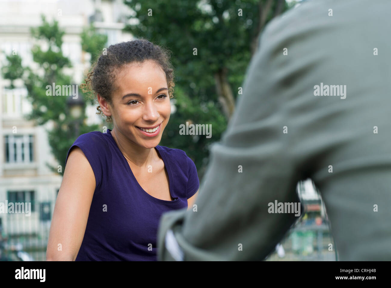 Young woman hanging out with friend outdoors Stock Photo - Alamy