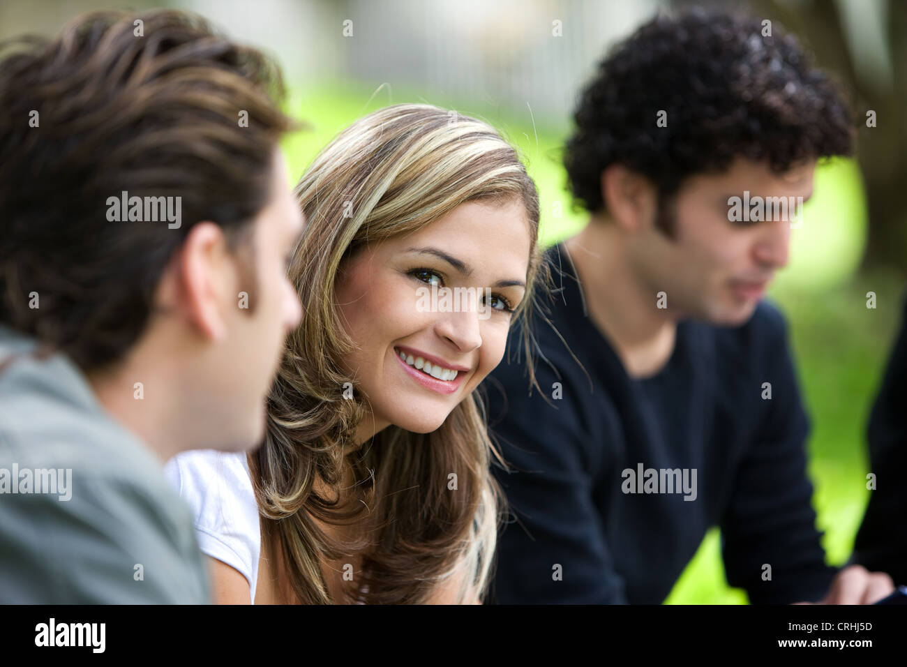 young cute woman sitting between two men, smiling Stock Photo - Alamy