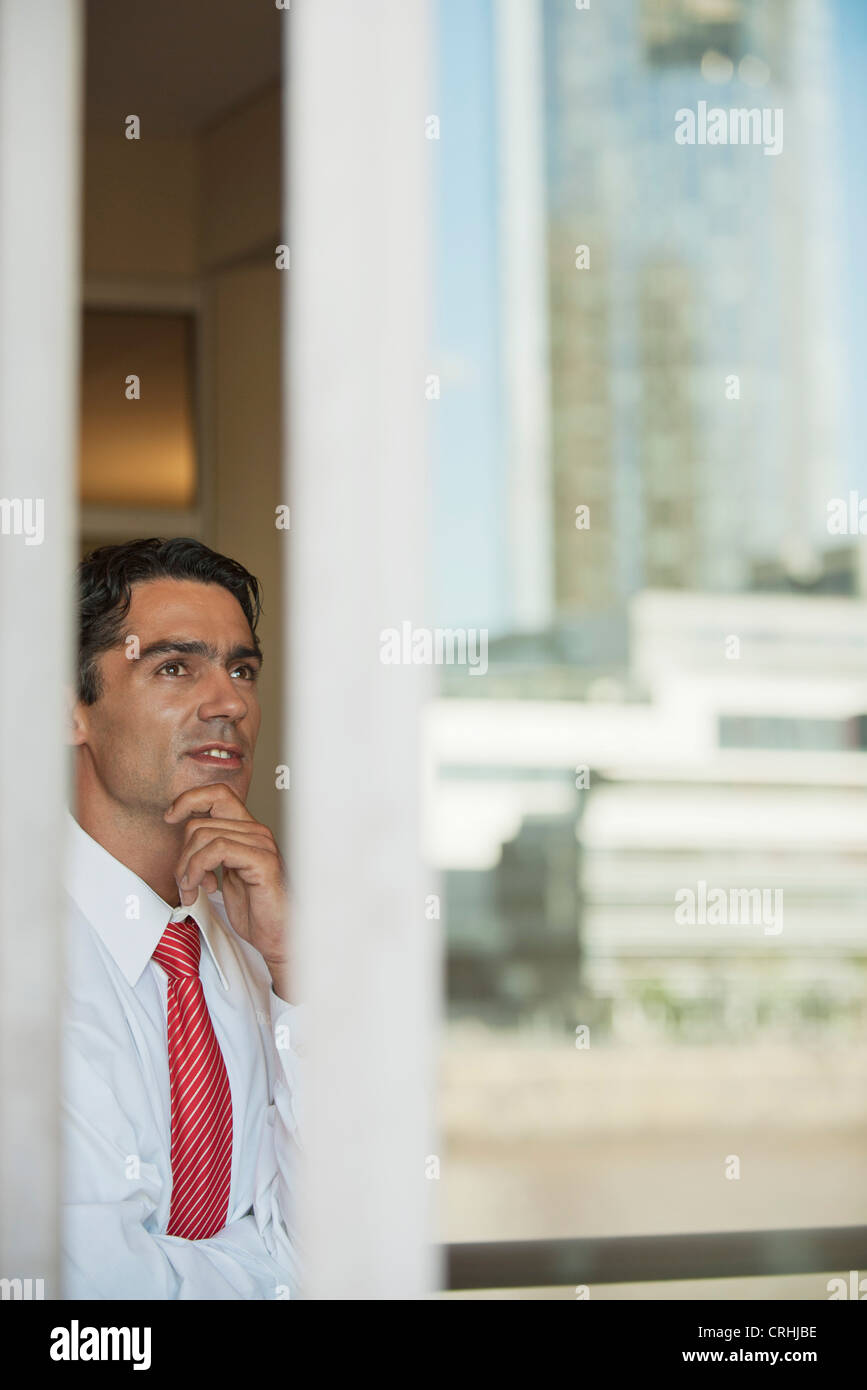 Businessman in office, seen from outside of window Stock Photo - Alamy
