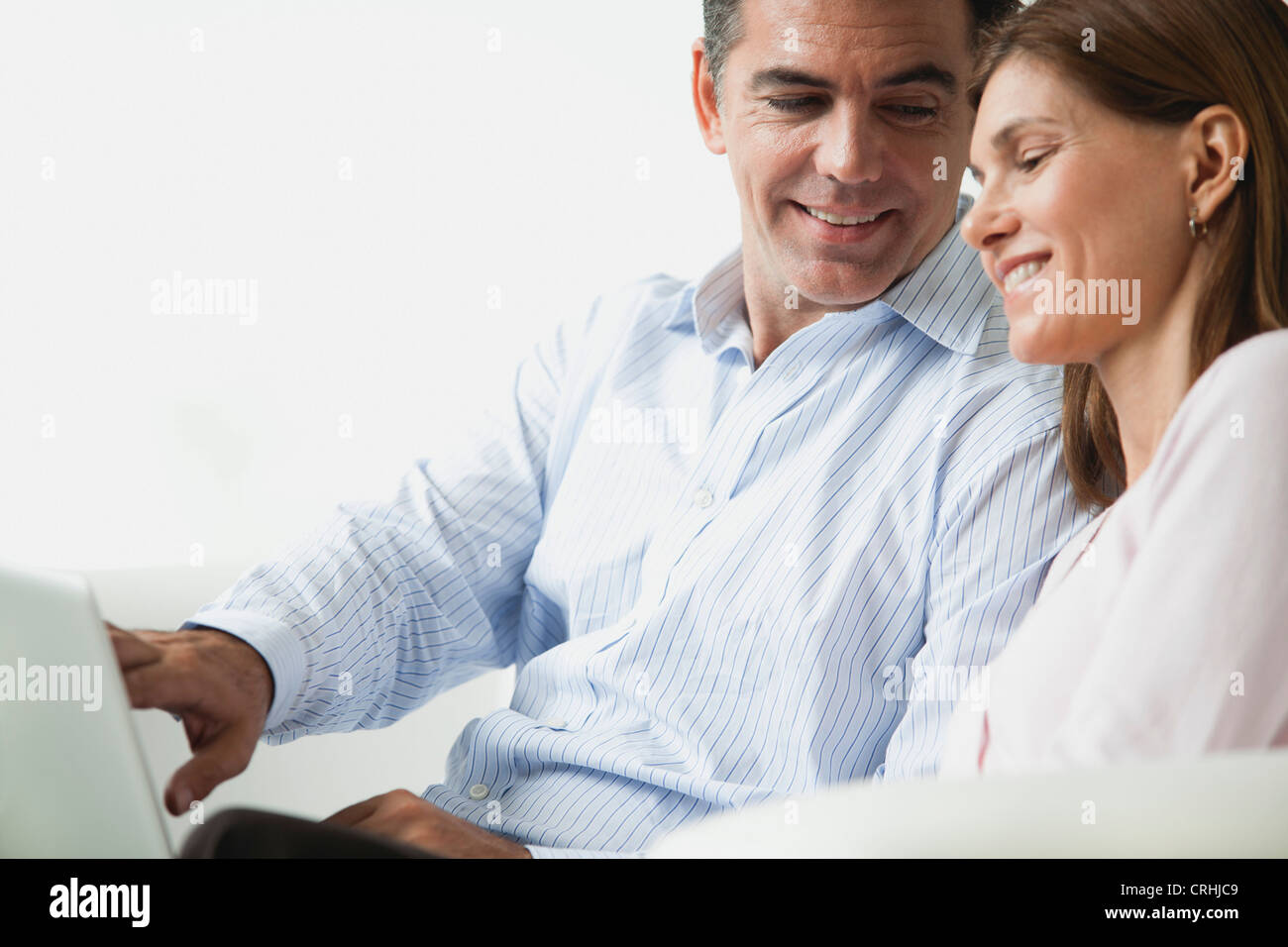 Couple looking at laptop computer together Stock Photo - Alamy
