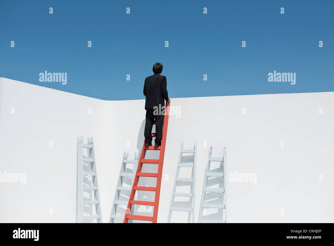 Businessman climbing ladder, rear view Stock Photo - Alamy