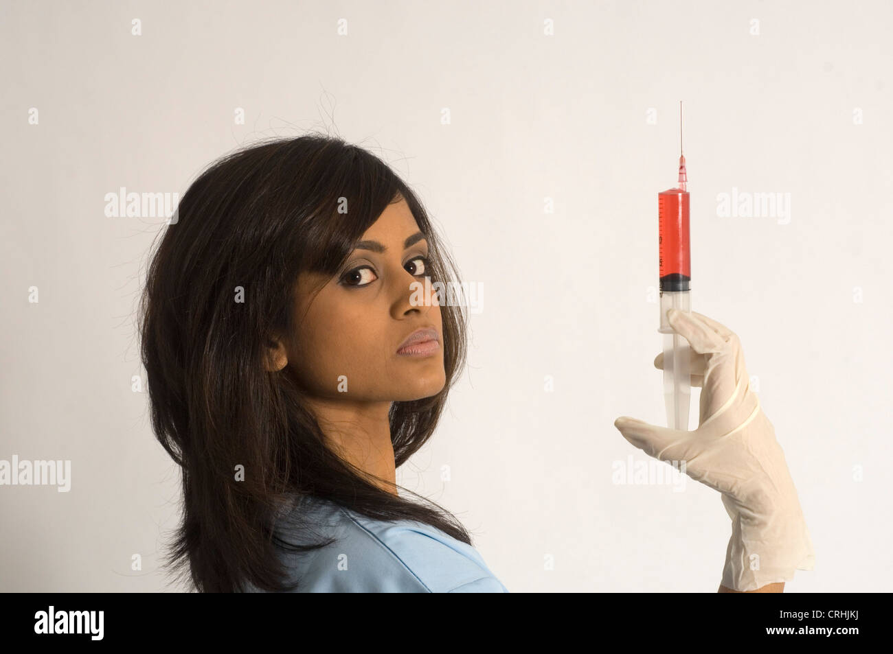 Female nurse preparing injection syringe Stock Photo - Alamy