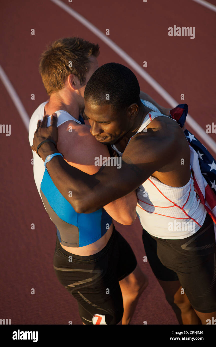 American running teammates embracing after race Stock Photo - Alamy