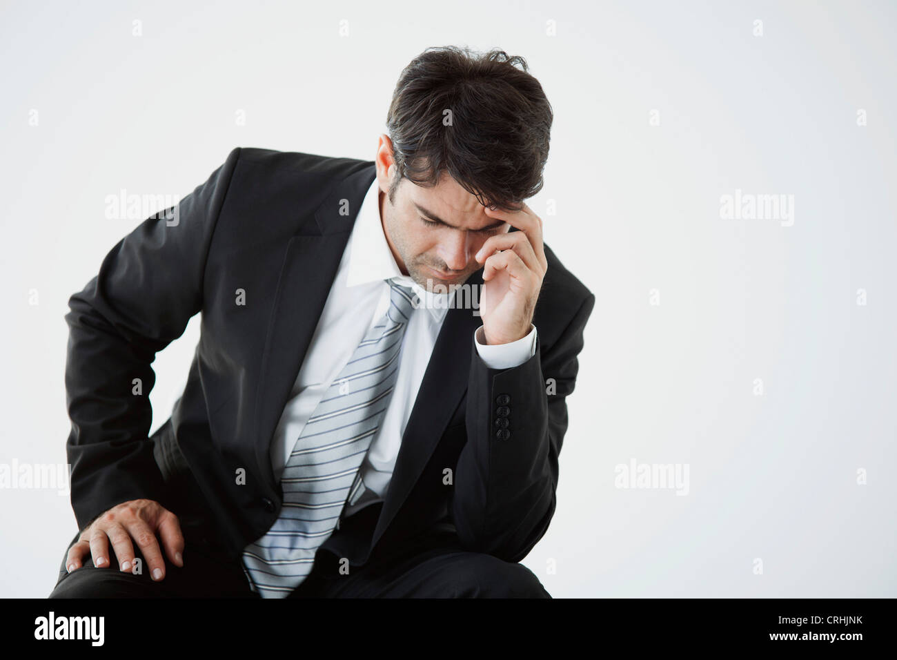 Businessman deep in thought facing difficulty Stock Photo - Alamy