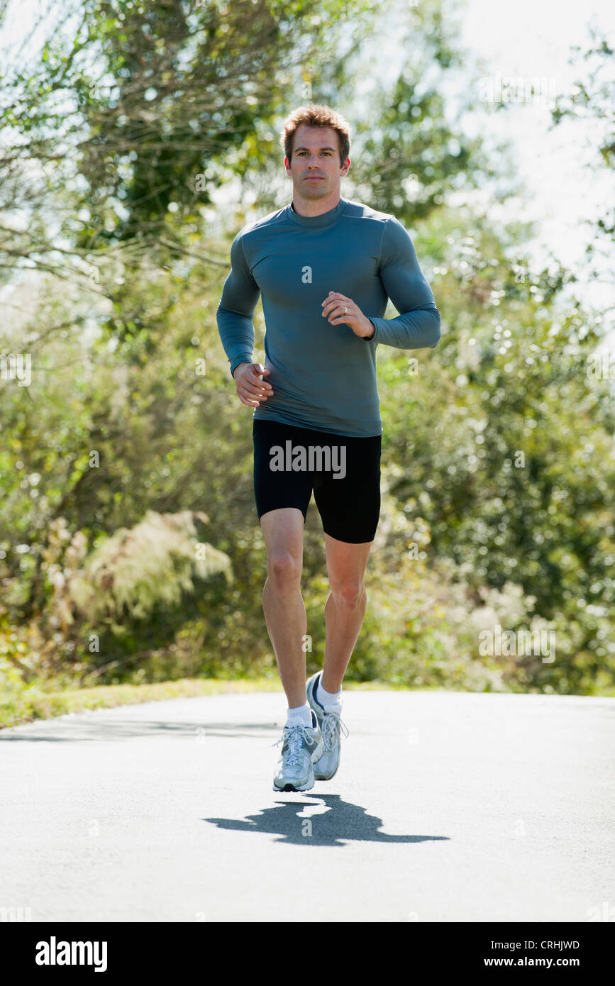 Mid-adult man jogging Stock Photo - Alamy