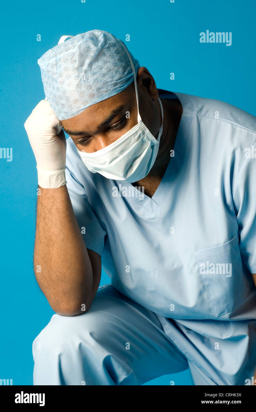 A surgeon holds his head in disbelief Stock Photo - Alamy