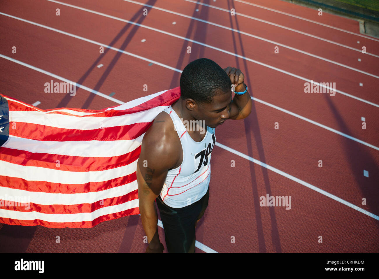 Runner holding up American flag after race Stock Photo - Alamy