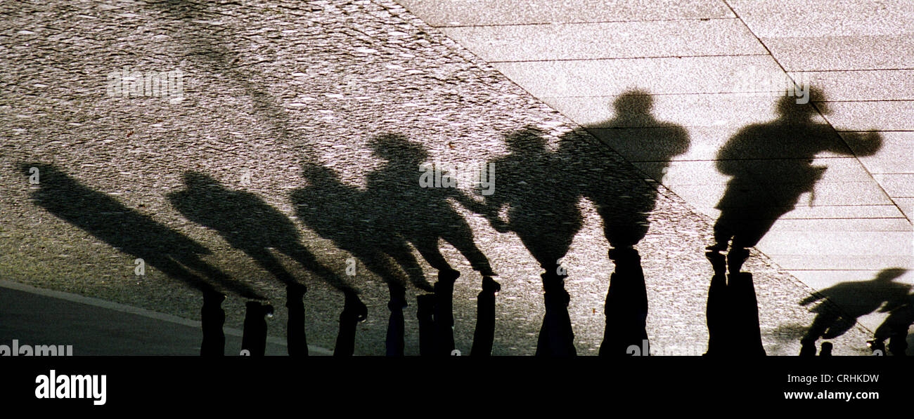 Shadows of several people in a row Stock Photo - Alamy