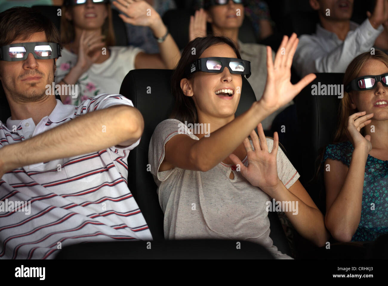 Audience enjoying 3-D movie in theater Stock Photo - Alamy