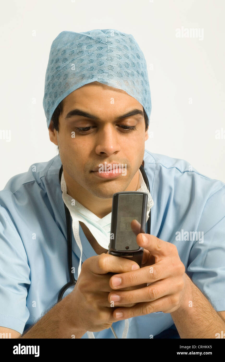 A sureon using his mobile phone Stock Photo - Alamy