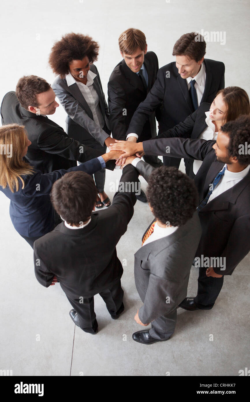 Business team members link hands in motivational exercise Stock Photo ...
