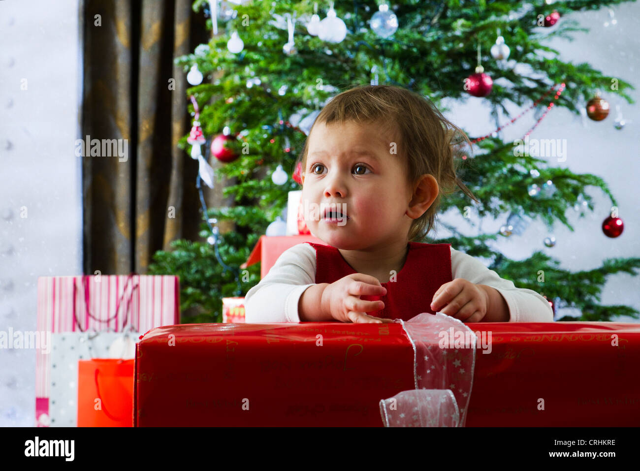 Baby girl opening Christmas present Stock Photo - Alamy