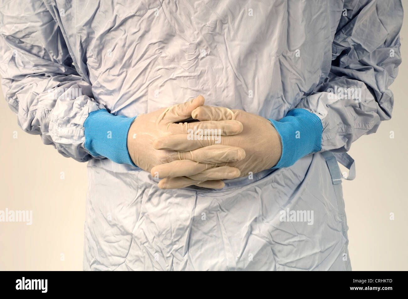Surgeon clasping gloved hands in front of his stomach Stock Photo - Alamy