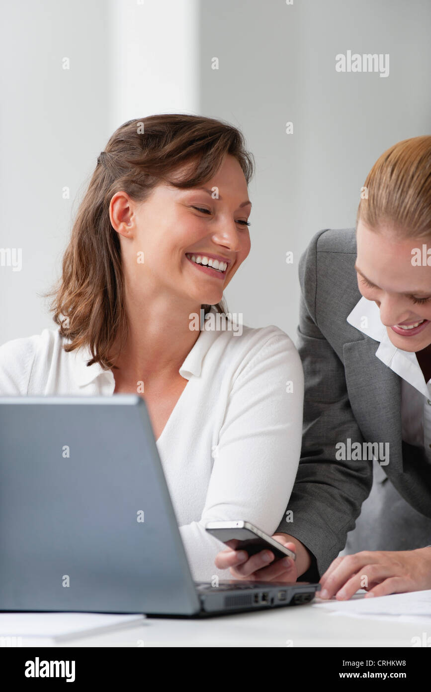 Woman two smartphones laptop hi-res stock photography and images - Alamy