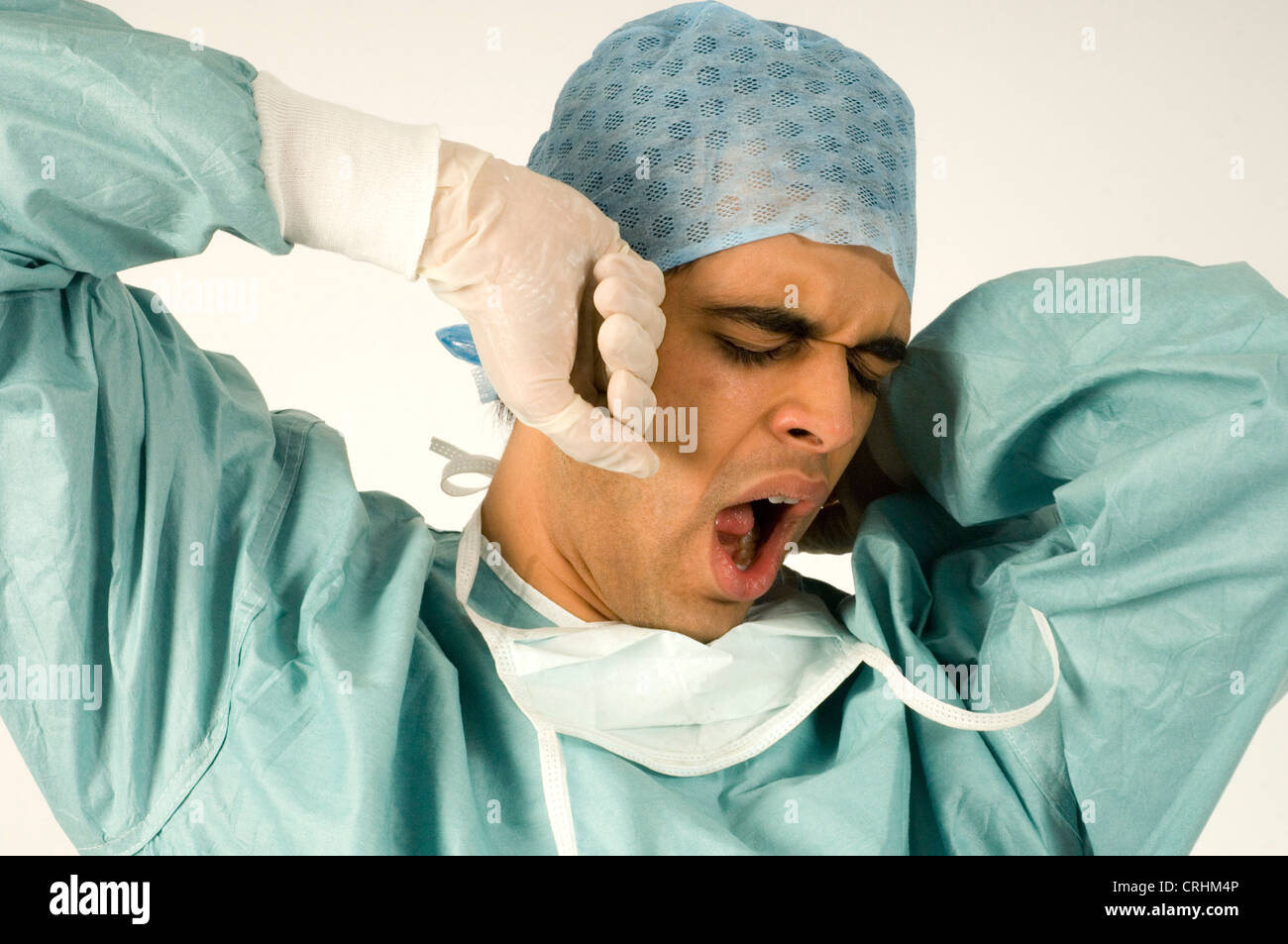 Tired surgeon stretching and yawning Stock Photo - Alamy