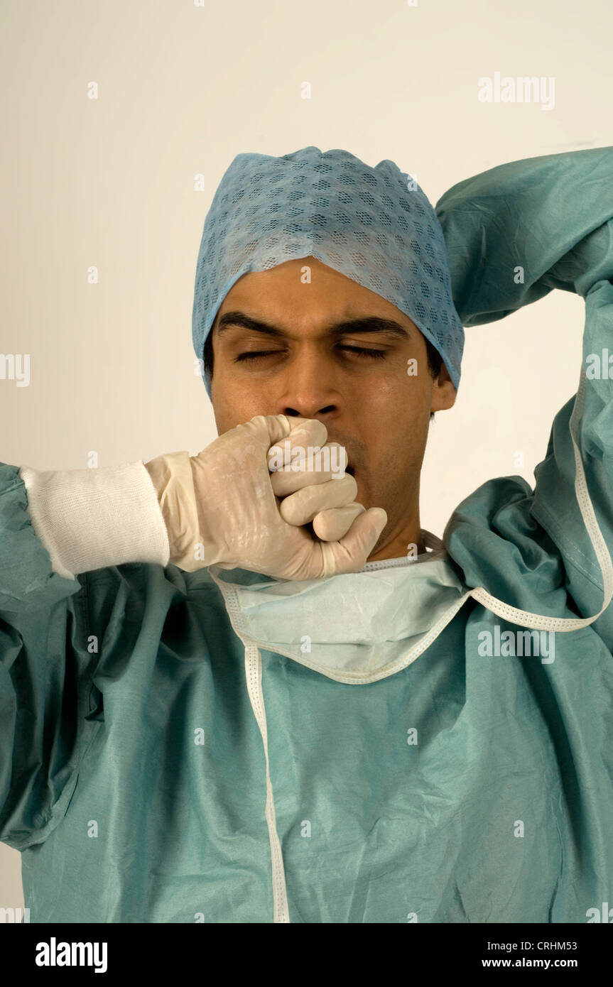 Tired surgeon stretching and yawning Stock Photo - Alamy