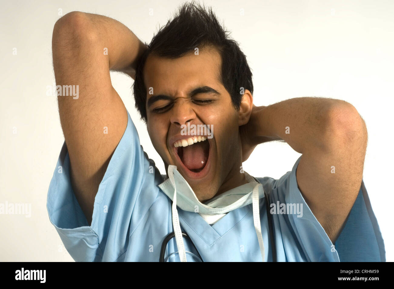 Tired surgeon yawning Stock Photo - Alamy